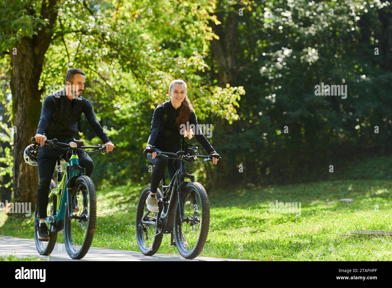 A blissful couple, adorned in professional cycling gear, enjoys a ...