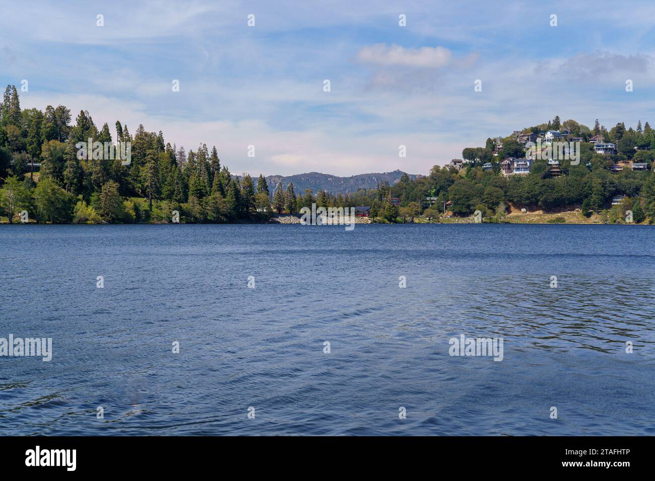 View of the water, shoreline, and mountains at Lake Gregory Regional ...