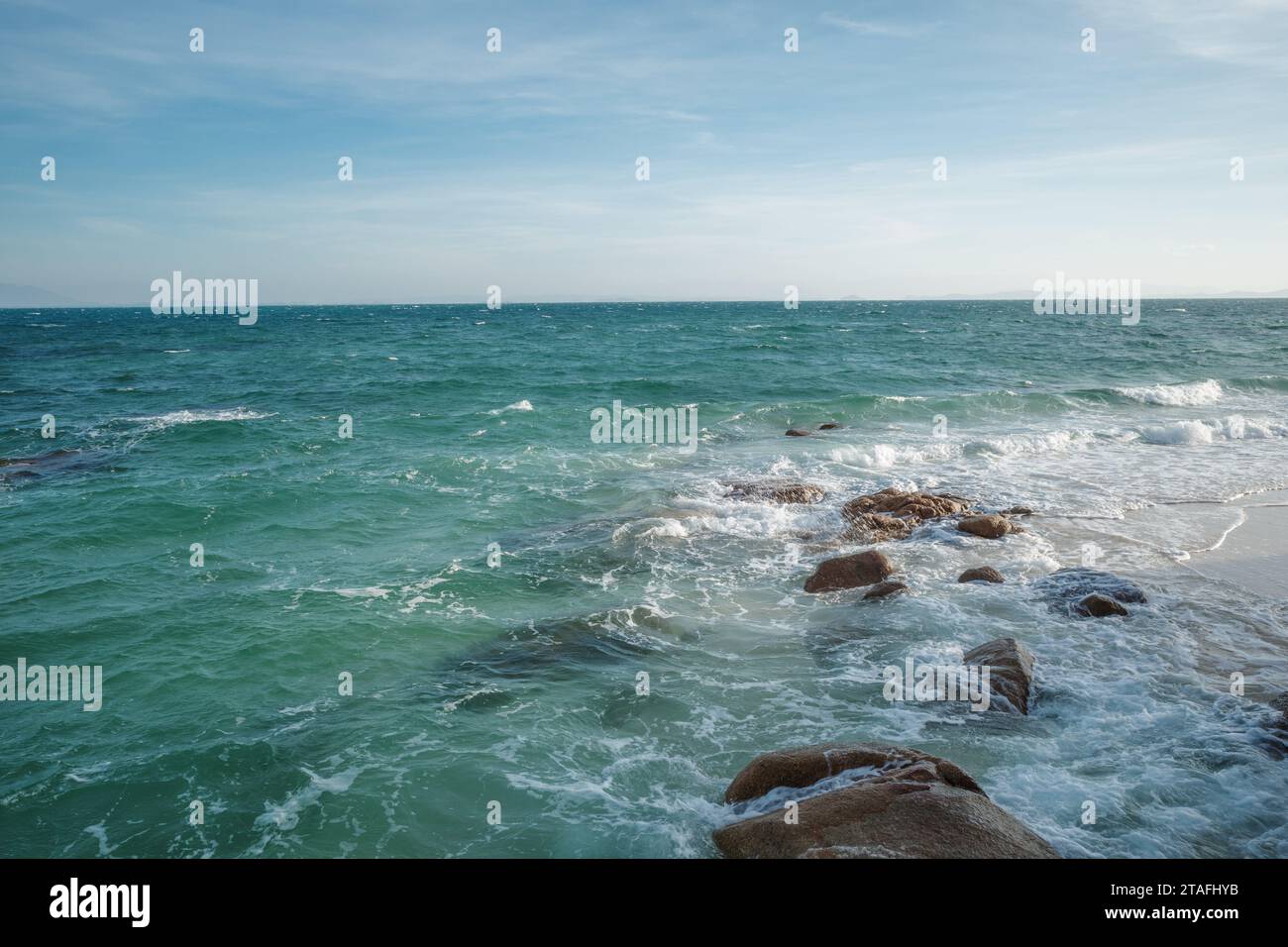 Outdoor scenery view over sea waves with clear water crushing over the ...