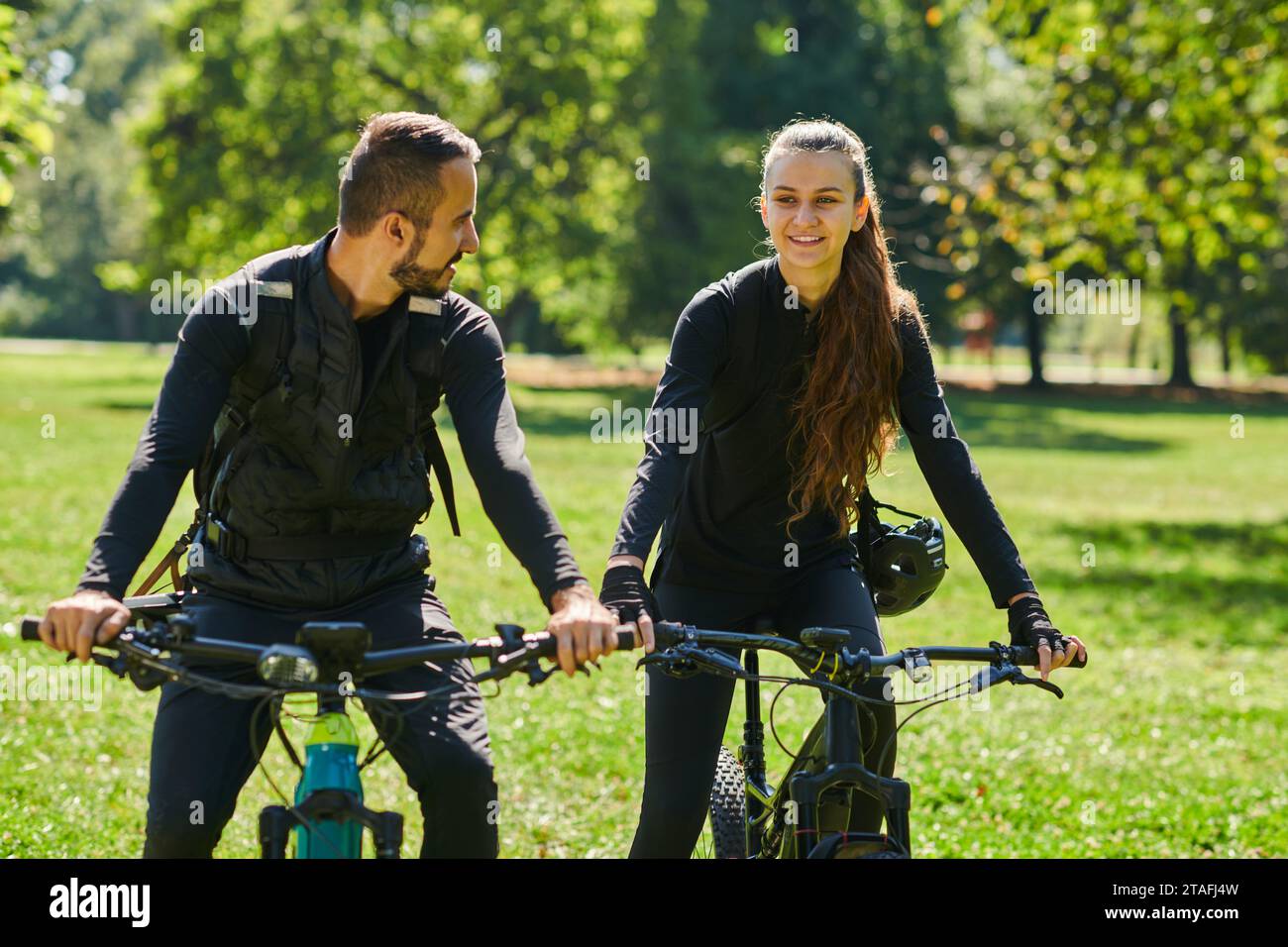 A blissful couple, adorned in professional cycling gear, enjoys a ...