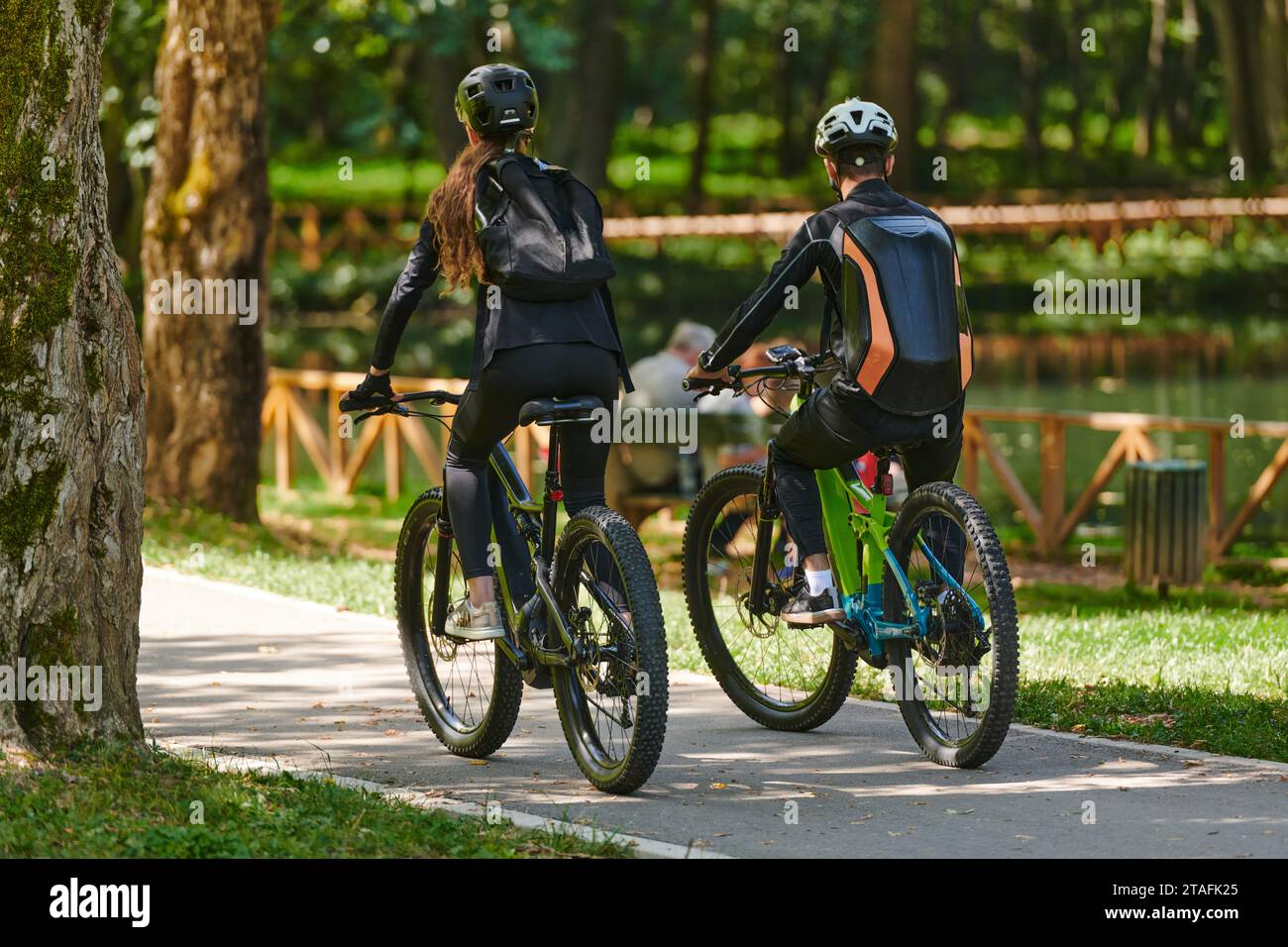 A blissful couple, adorned in professional cycling gear, enjoys a ...