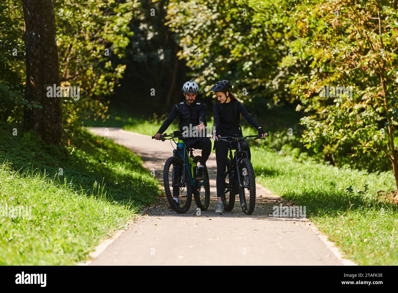 A blissful couple, adorned in professional cycling gear, enjoys a ...