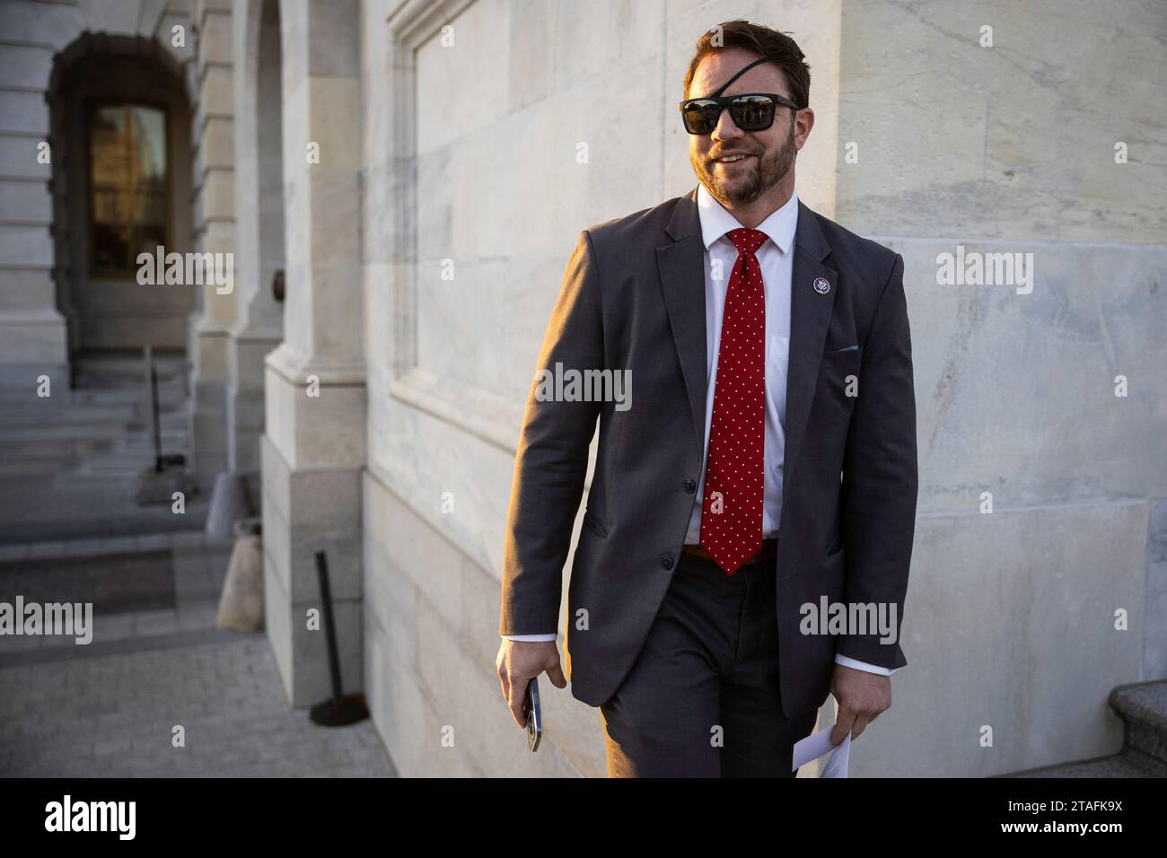 Rep. Dan Crenshaw (R-Texas) speaks with reporters as he arrives for a ...