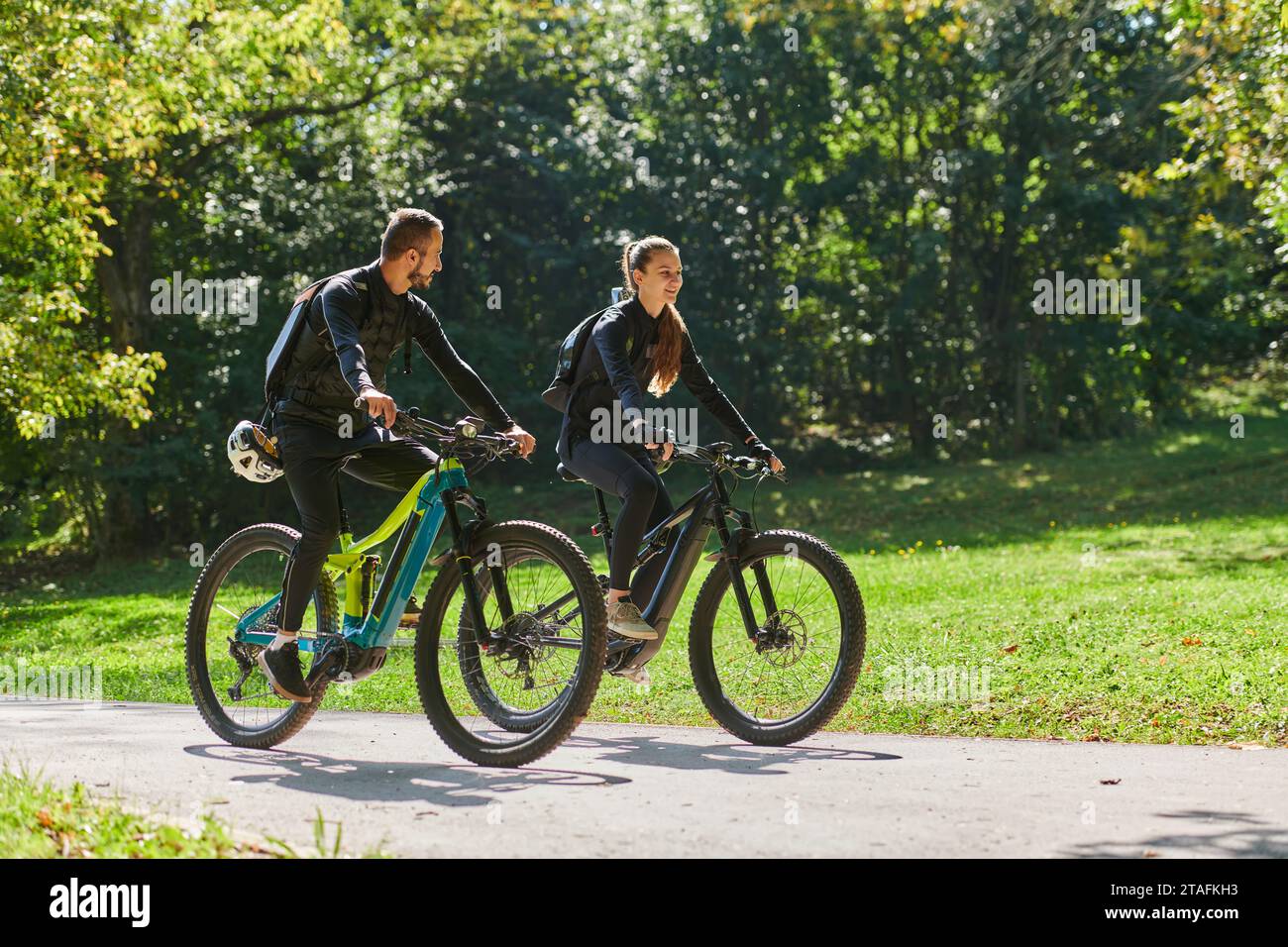 A blissful couple, adorned in professional cycling gear, enjoys a ...