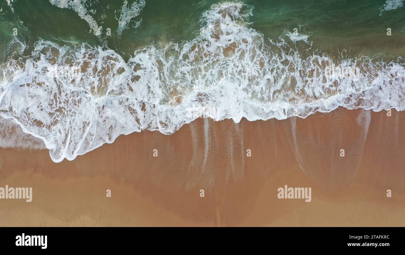 Sea wave on beach aerial view. Coast with waves as background from top ...