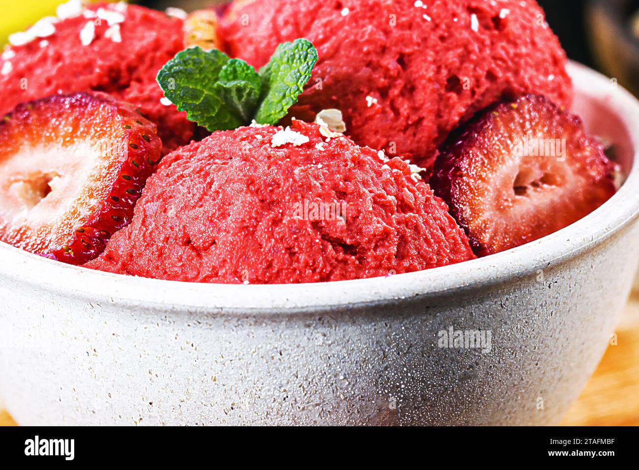 vegan strawberry ice cream with tropical fruits in the background ...