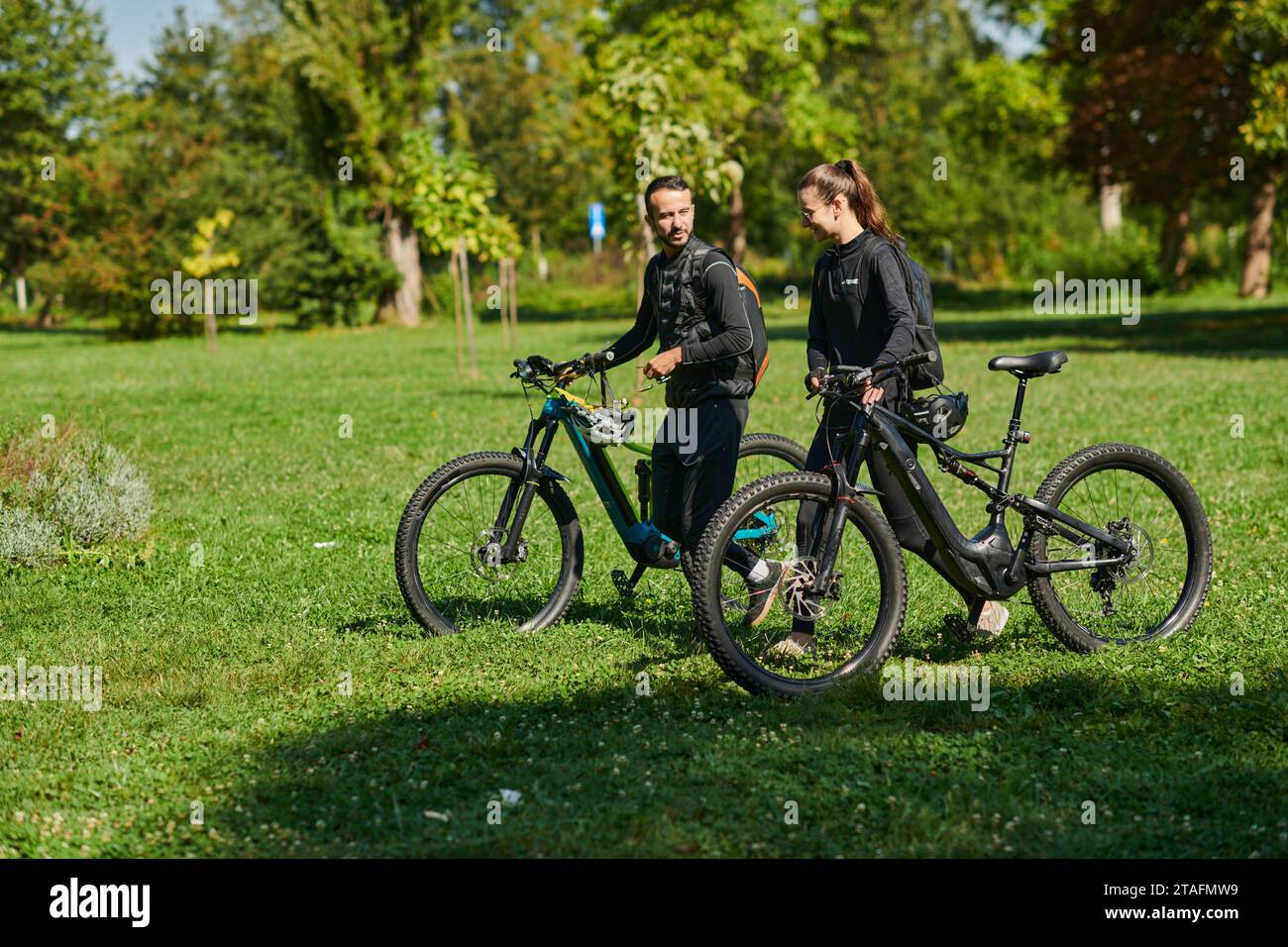 A blissful couple, adorned in professional cycling gear, enjoys a ...