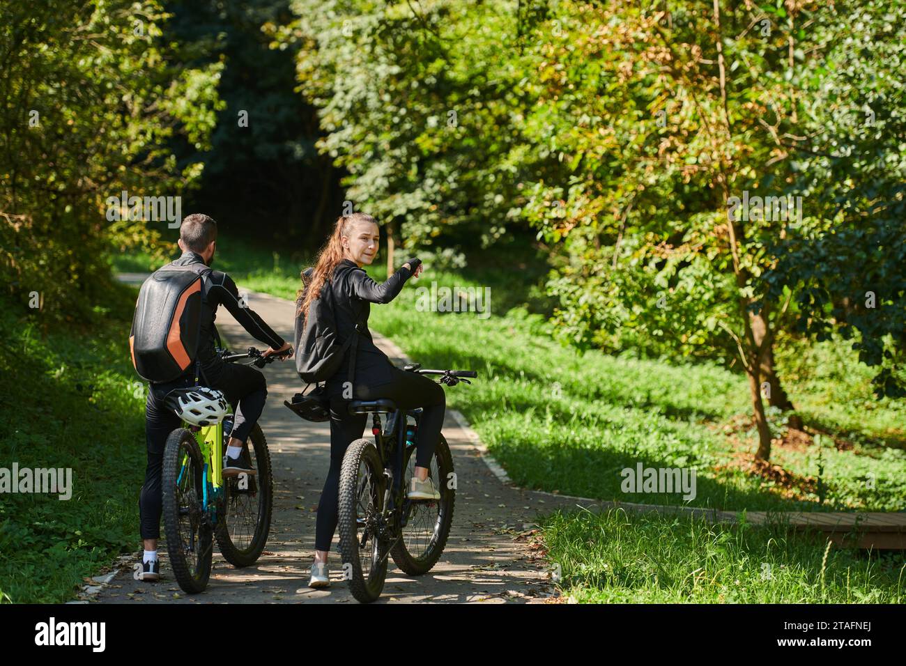 A blissful couple, adorned in professional cycling gear, enjoys a ...
