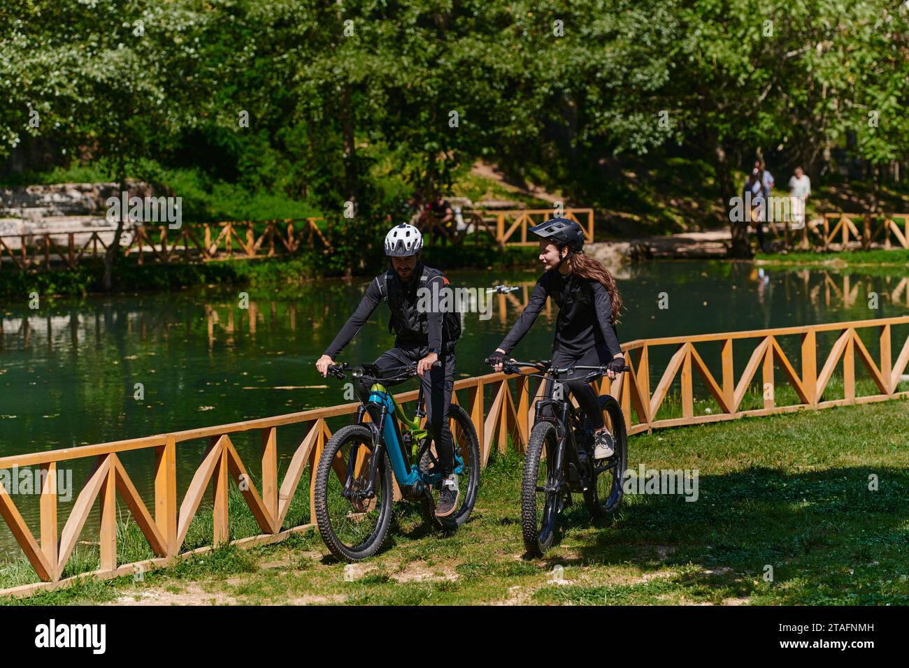 A blissful couple, adorned in professional cycling gear, enjoys a ...