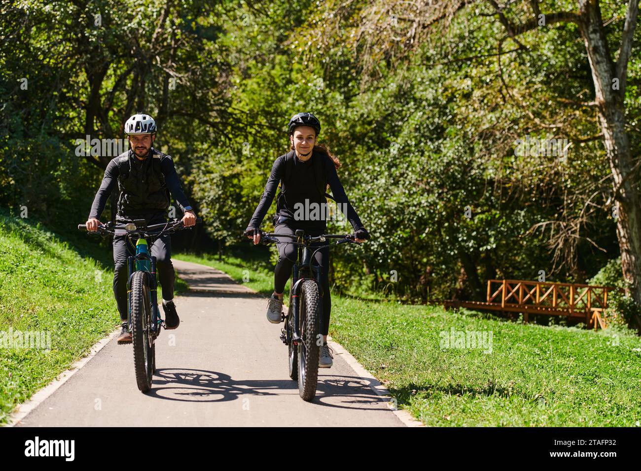 A blissful couple, adorned in professional cycling gear, enjoys a ...