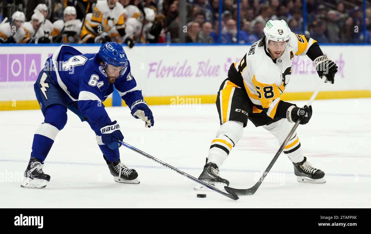 Pittsburgh Penguins defenseman Kris Letang (58) passes the puck around ...