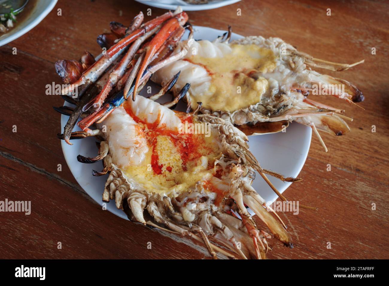 Cutting half grilled giant river prawn, famous local Thai luxury fine ...
