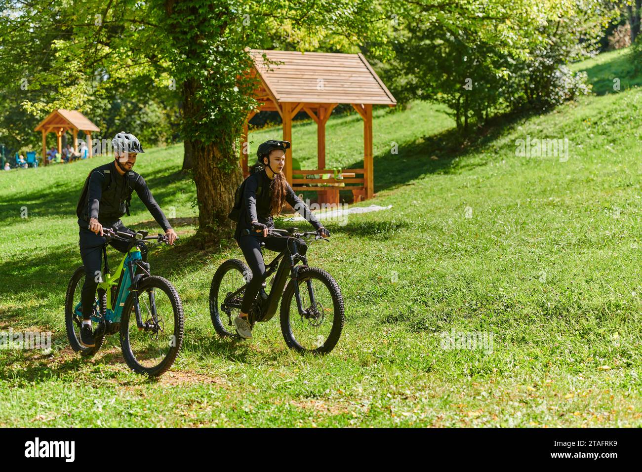 A blissful couple, adorned in professional cycling gear, enjoys a ...