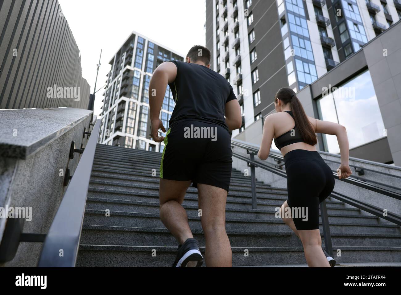 Two friends run up stairs hi-res stock photography and images - Alamy