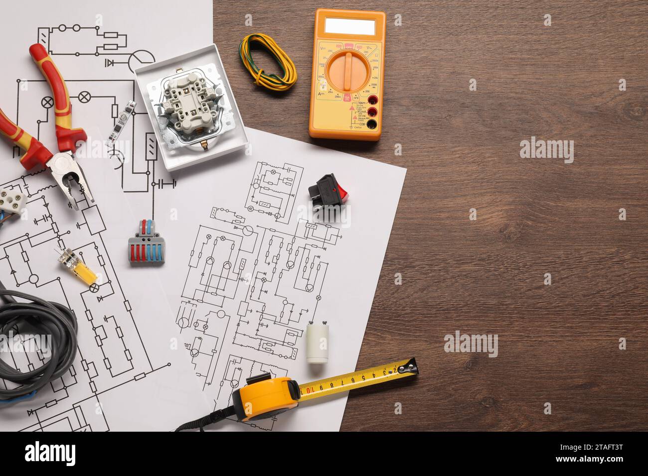 Flat lay composition with wiring diagrams and digital multimeter on ...