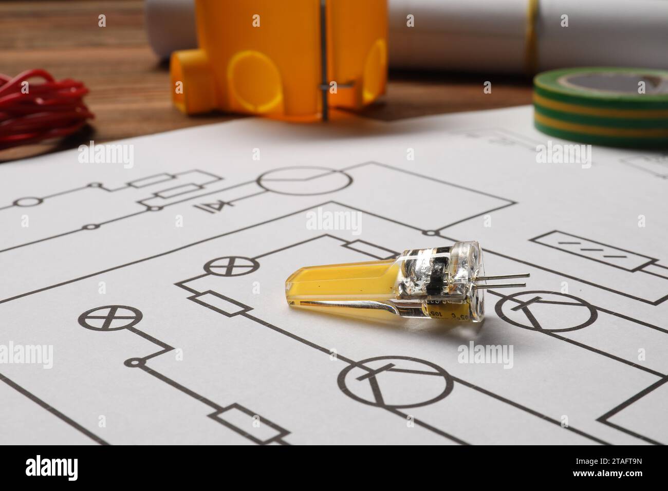 Wiring diagram and different electrician's equipment on table, closeup ...