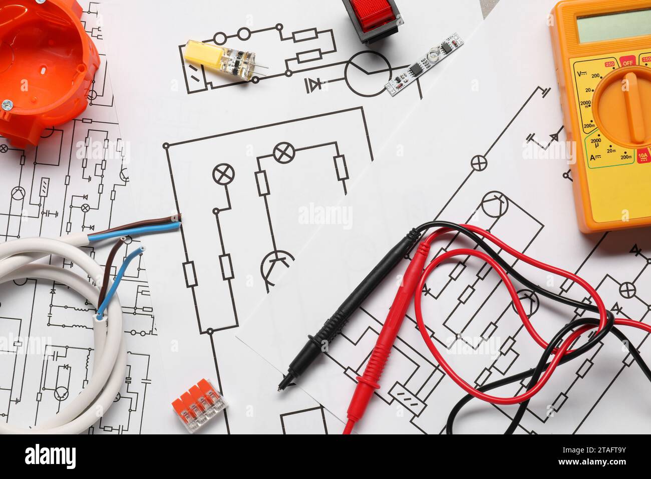 Digital multimeter and other electrician's equipment on wiring diagrams ...
