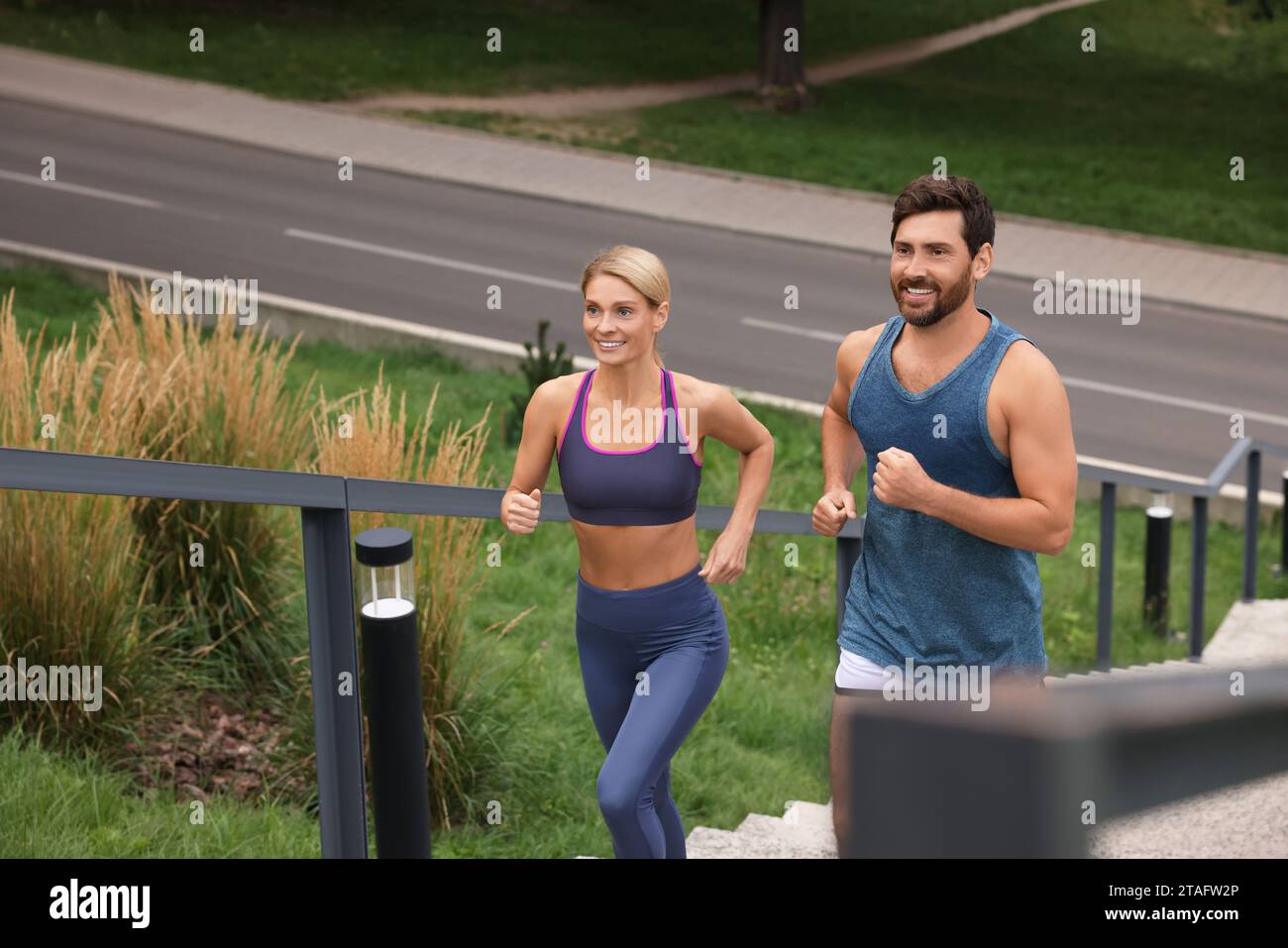 Two friends run up stairs hi-res stock photography and images - Alamy