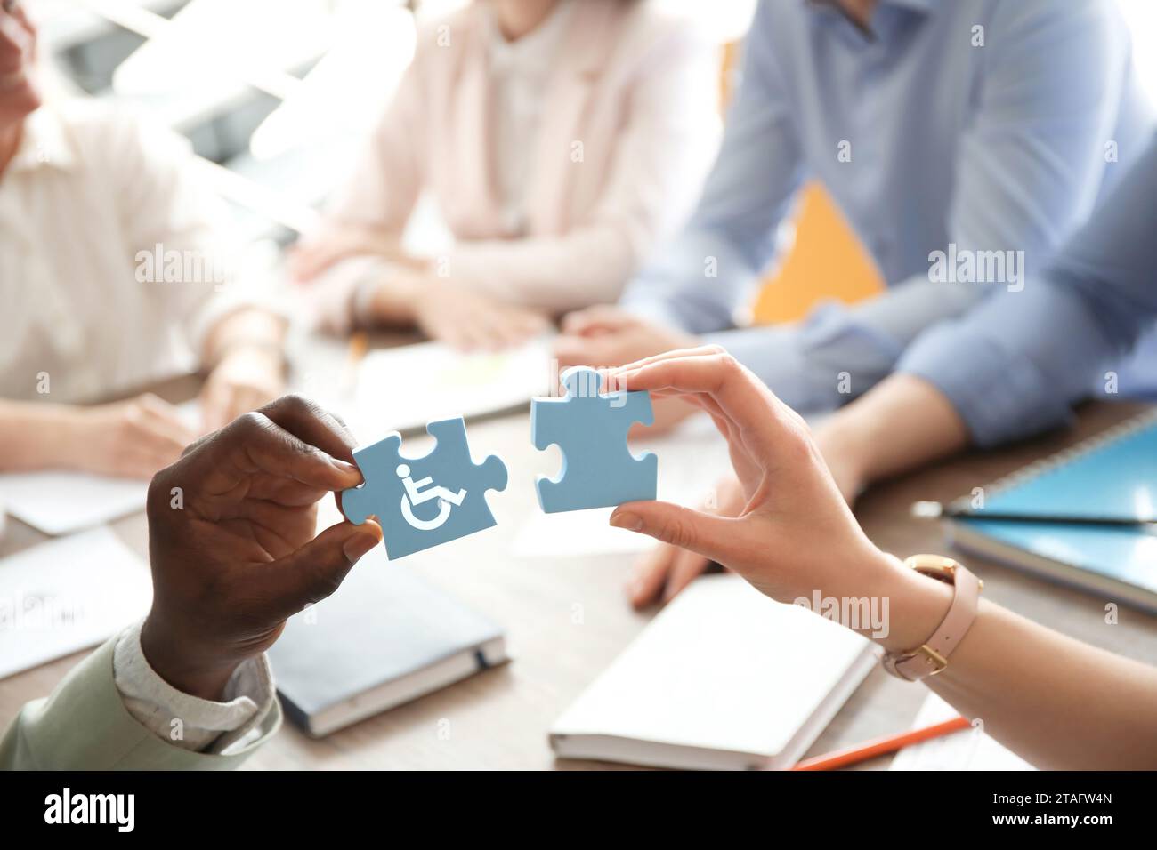 Inclusive workplace culture. People joining puzzle pieces indoors ...