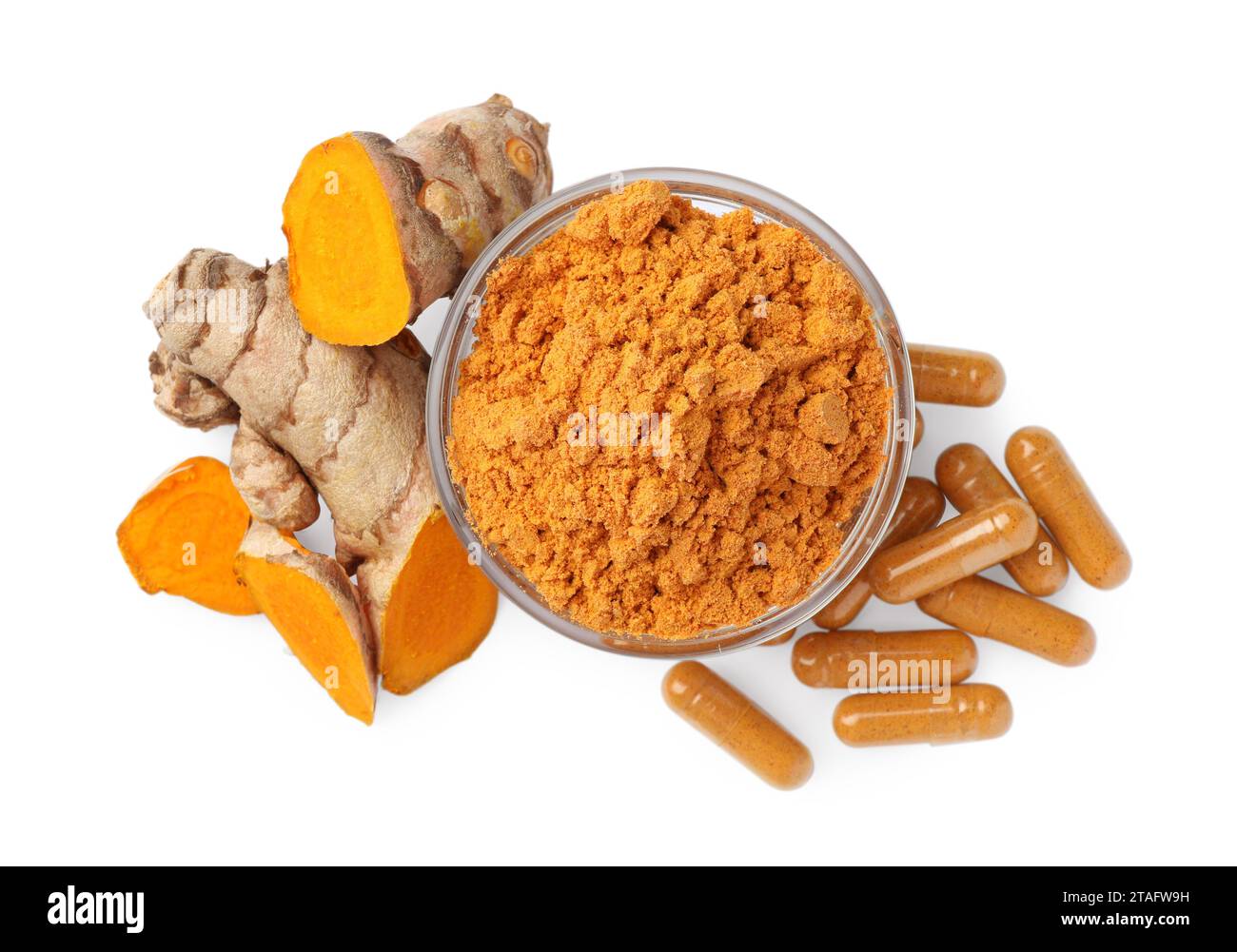 Bowl with aromatic turmeric powder, pills and cut roots isolated on ...