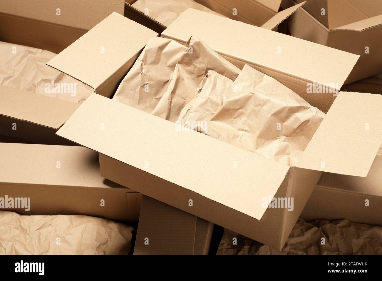 Many open cardboard boxes with crumpled paper as background Stock Photo ...