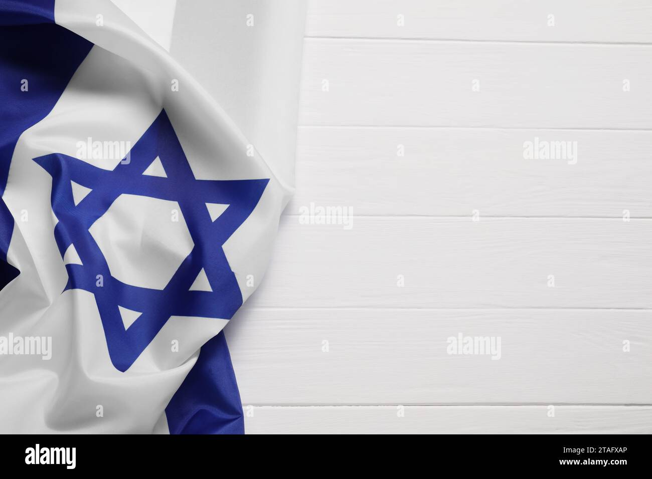 Flag of Israel on white wooden background, top view and space for text ...