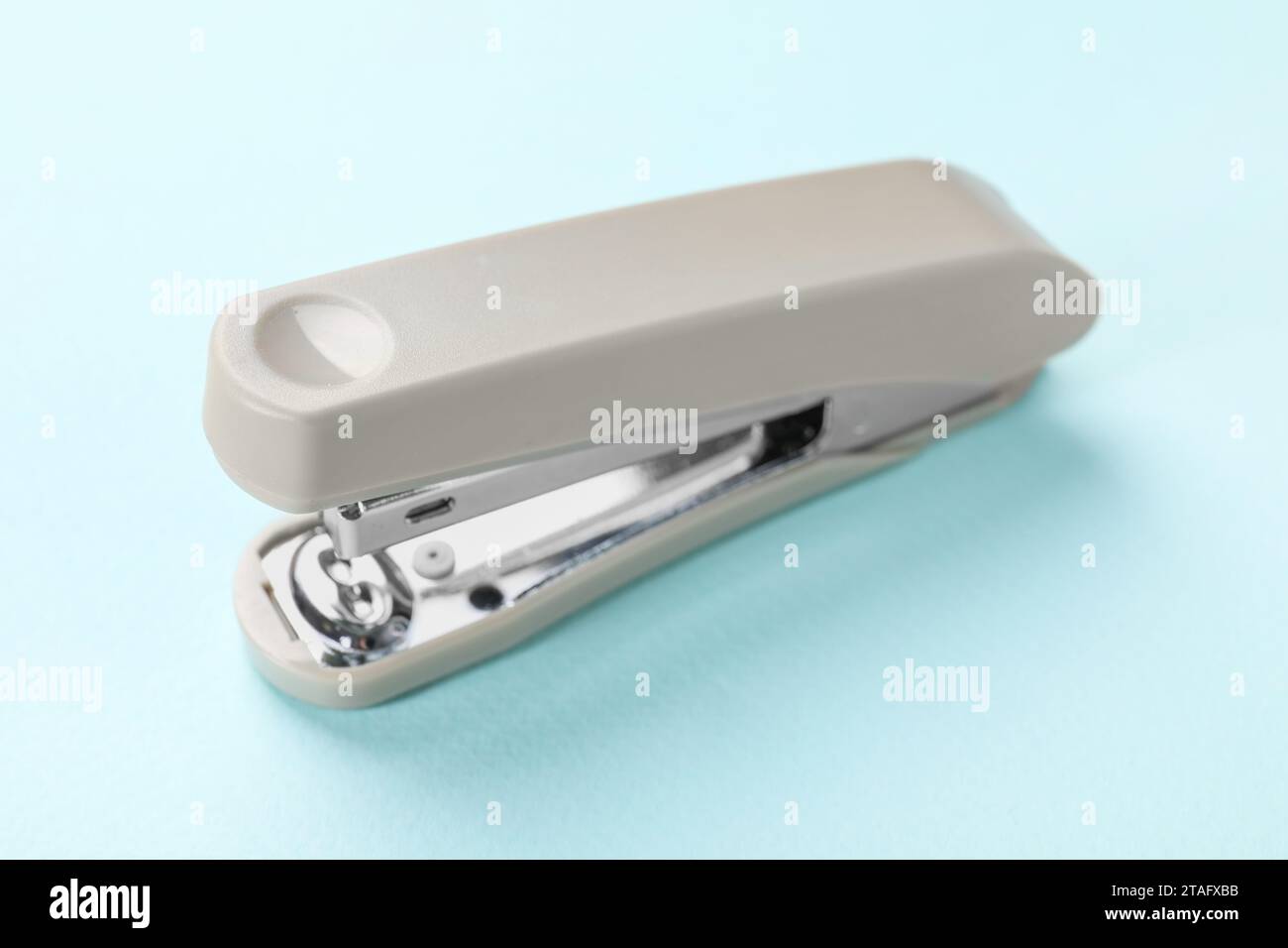 Beige stapler on light blue background, closeup Stock Photo - Alamy