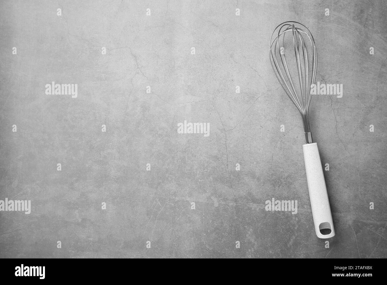 Metal whisk on gray table, top view. Space for text Stock Photo - Alamy