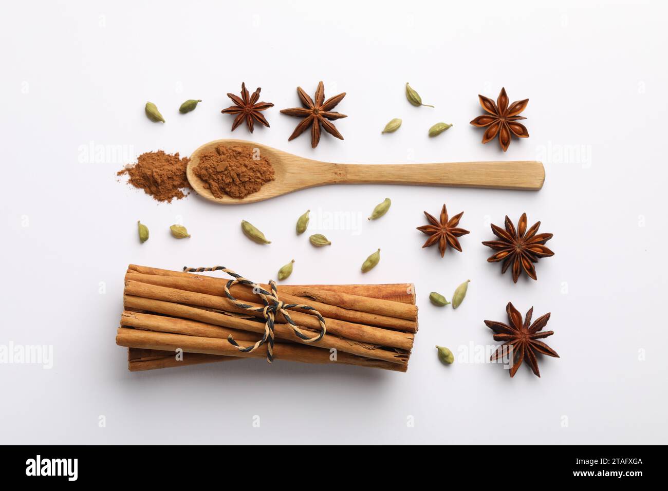 Cinnamon sticks, star anise and cardamom pods on white background, flat ...