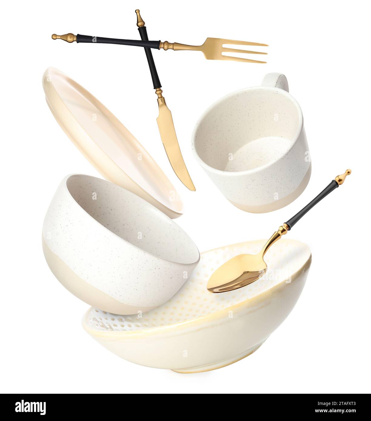 Clean dishes, cup and cutlery falling on white background Stock Photo ...