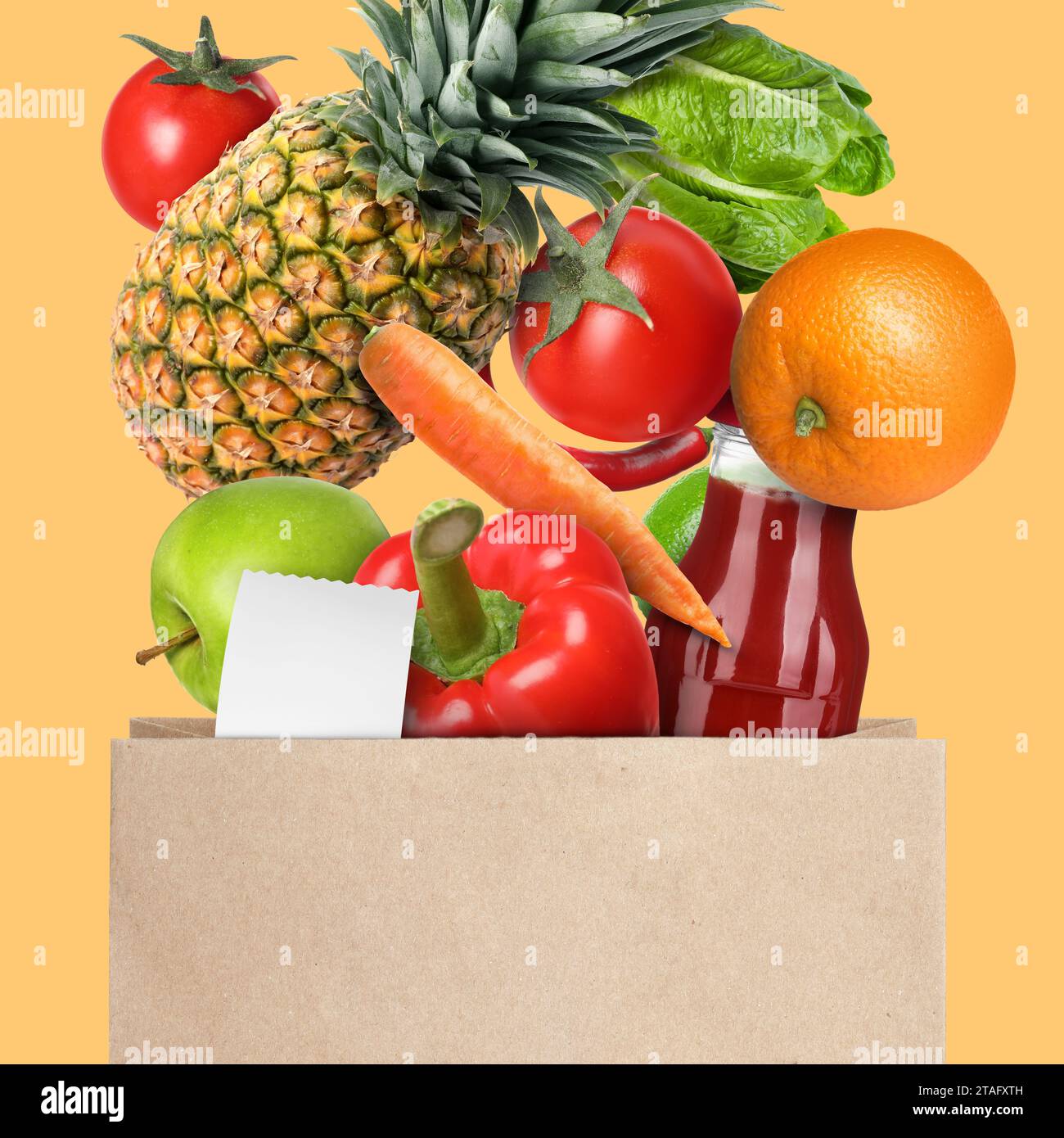 Different food products falling into paper bag on pale orange ...