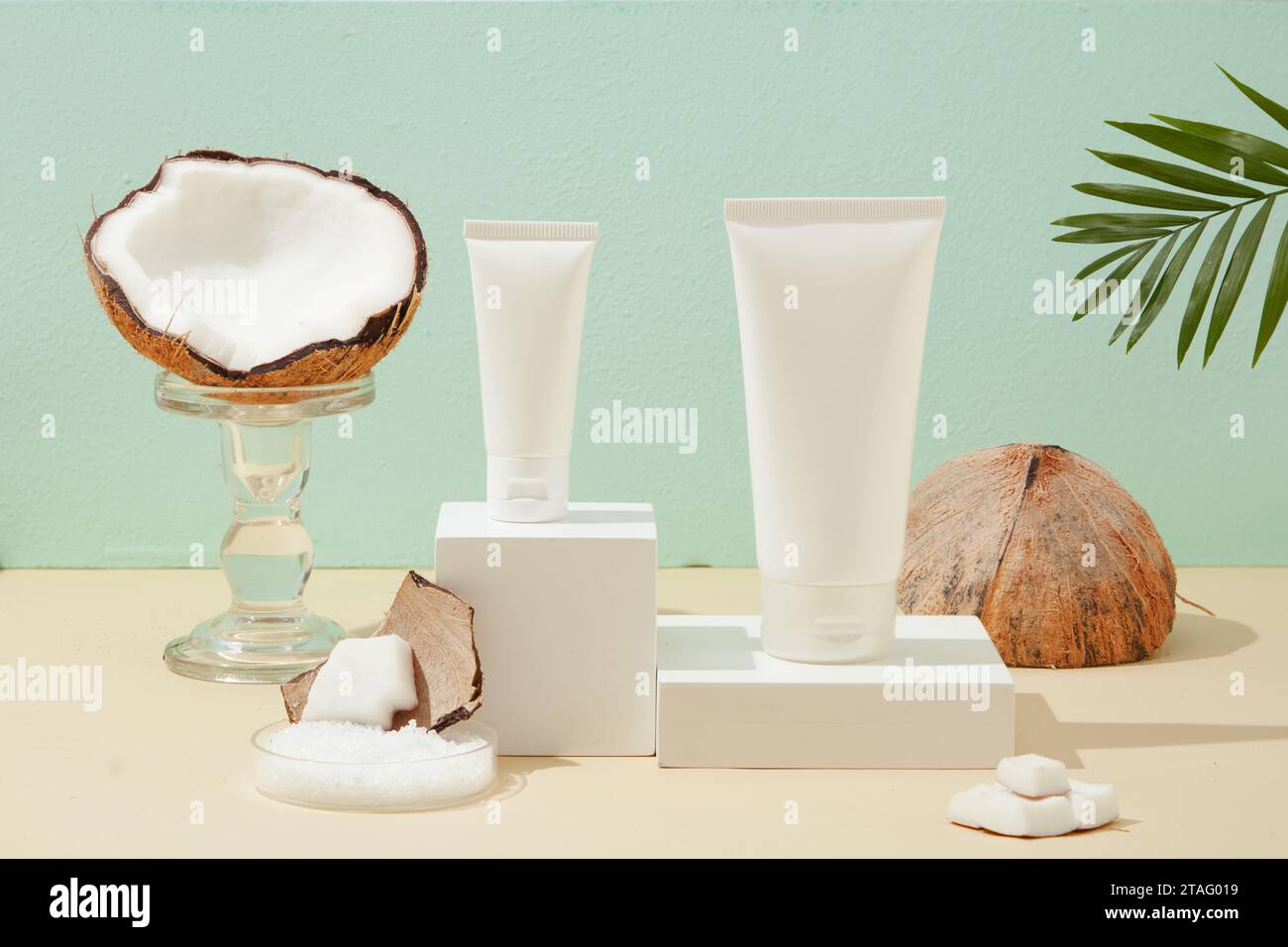 Two cosmetic tubes of two different sizes are placed on two white ...