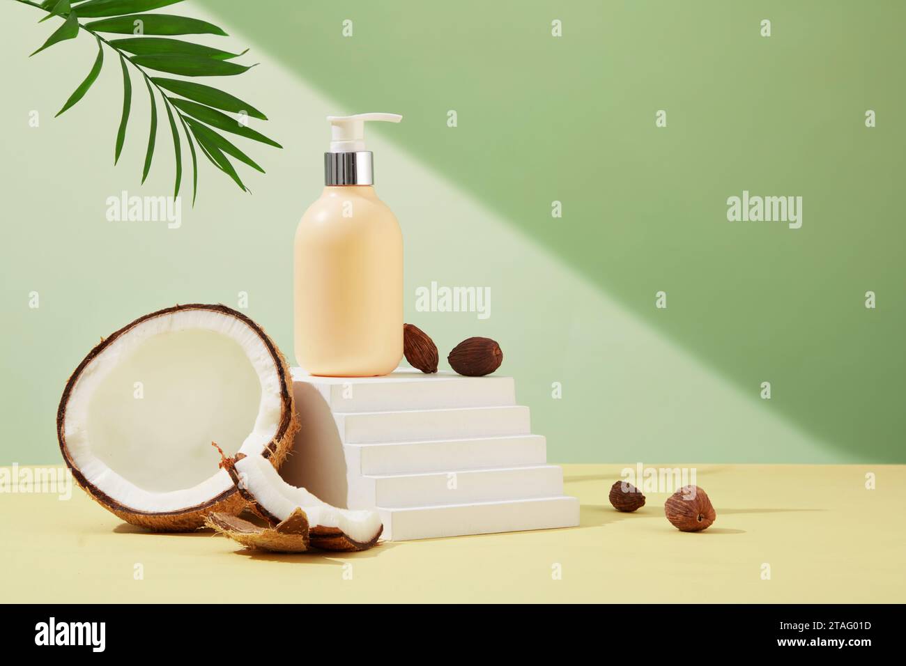 A light yellow shower gel bottle with a spray nozzle is placed on a ...