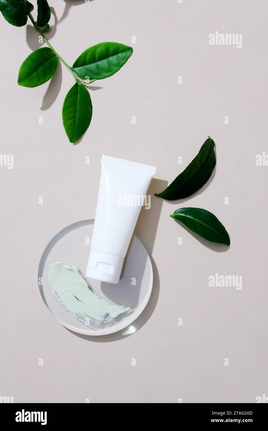 A smear of cream is displayed on a transparent platform along with a ...