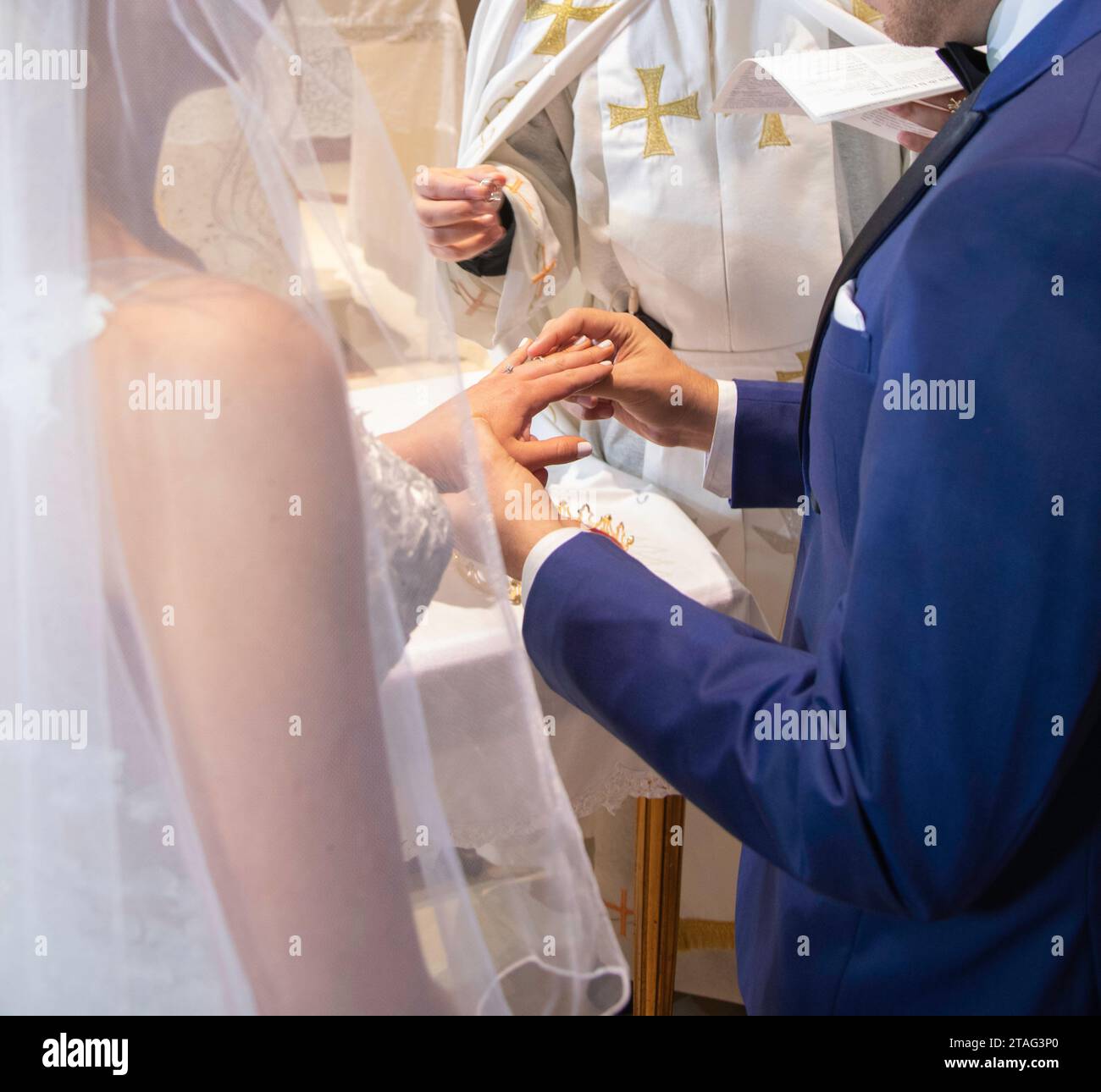 Groom putting ring on brides hi-res stock photography and images - Alamy