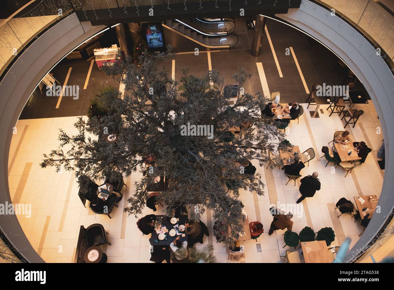 People sitting eating in food court, cafe, restaurant in shopping mall ...