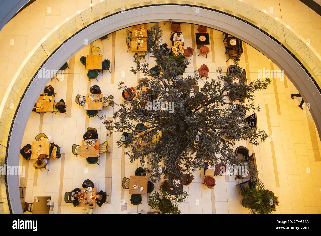 People sitting eating in food court, cafe, restaurant in shopping mall ...