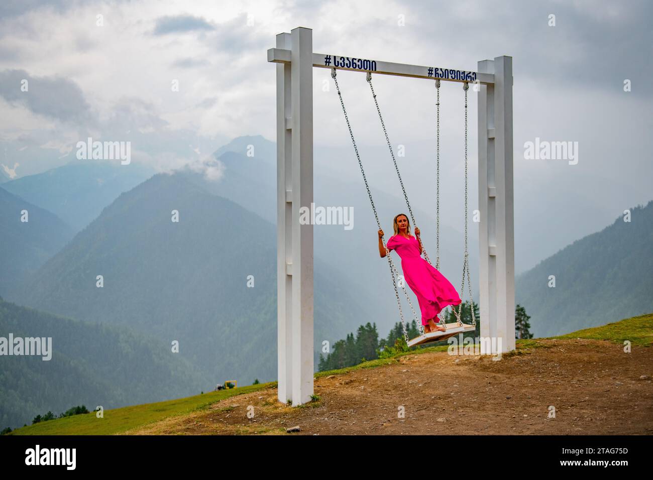 Dancing with swinging shadows, a girl in a pink dress on a swing Stock ...