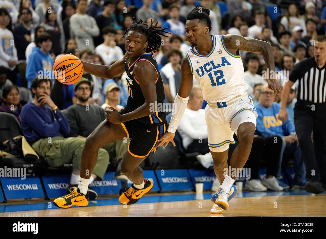 UC Riverside guard Nate Pickens, left, drives past UCLA guard Sebastian ...