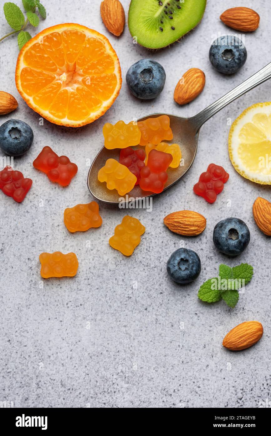 Chewable gummy bears vitamins and supplements and fresh fruits Stock ...