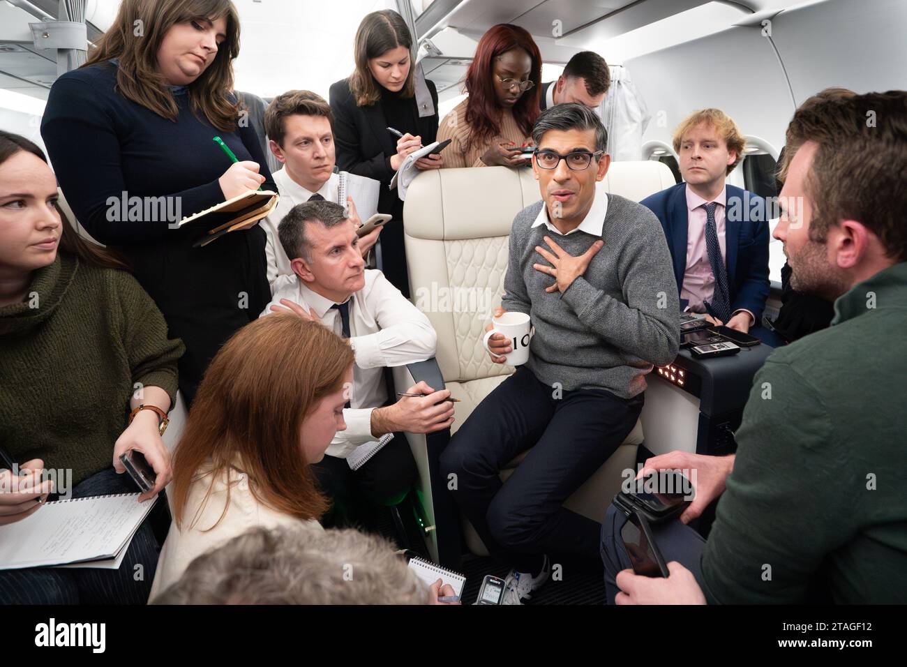 Prime Minister Rishi Sunak talks to journalists during his flight to ...