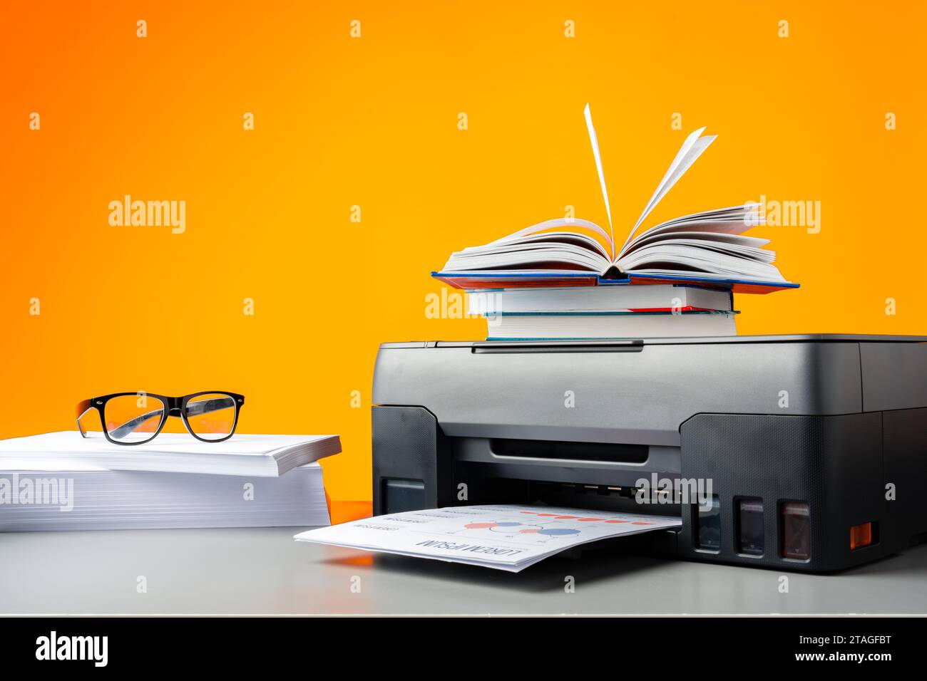 Laser printer on desk against yellow background Stock Photo - Alamy