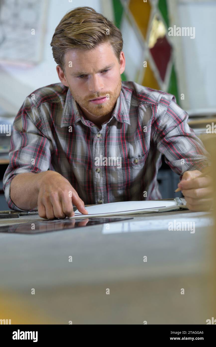 man concentrating while working at his desk Stock Photo - Alamy