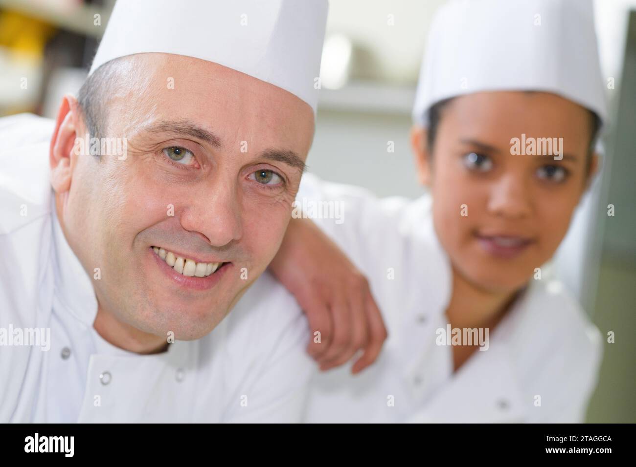 a portrait of chef and trainee Stock Photo - Alamy