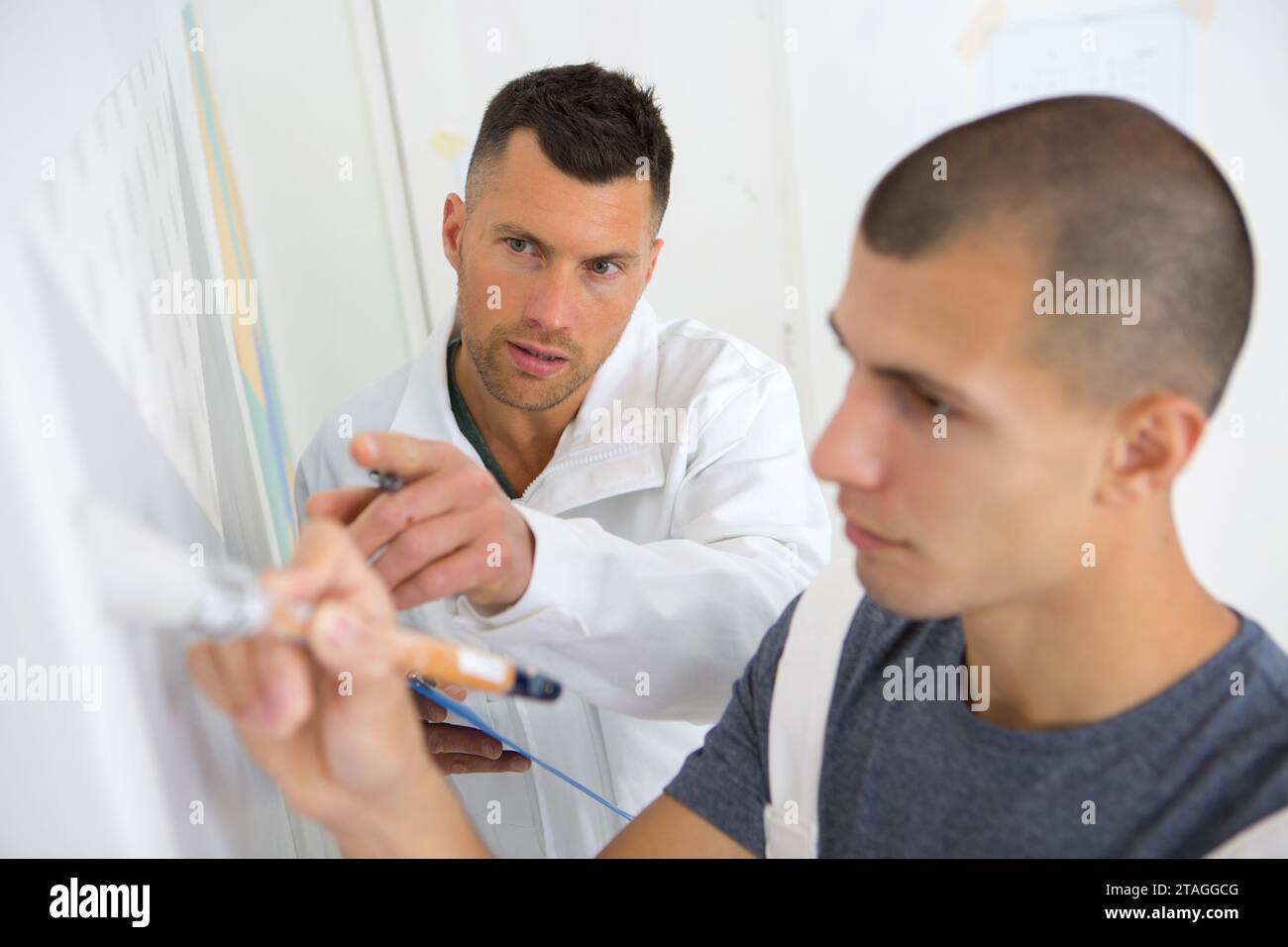 a painter with an apprentice Stock Photo - Alamy