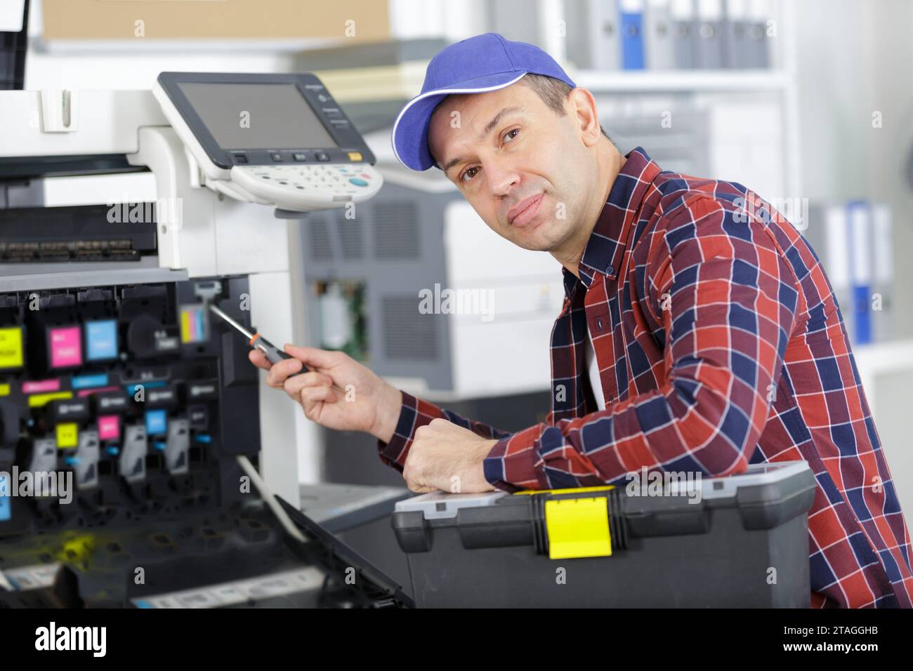 male technician fixing a printer Stock Photo - Alamy