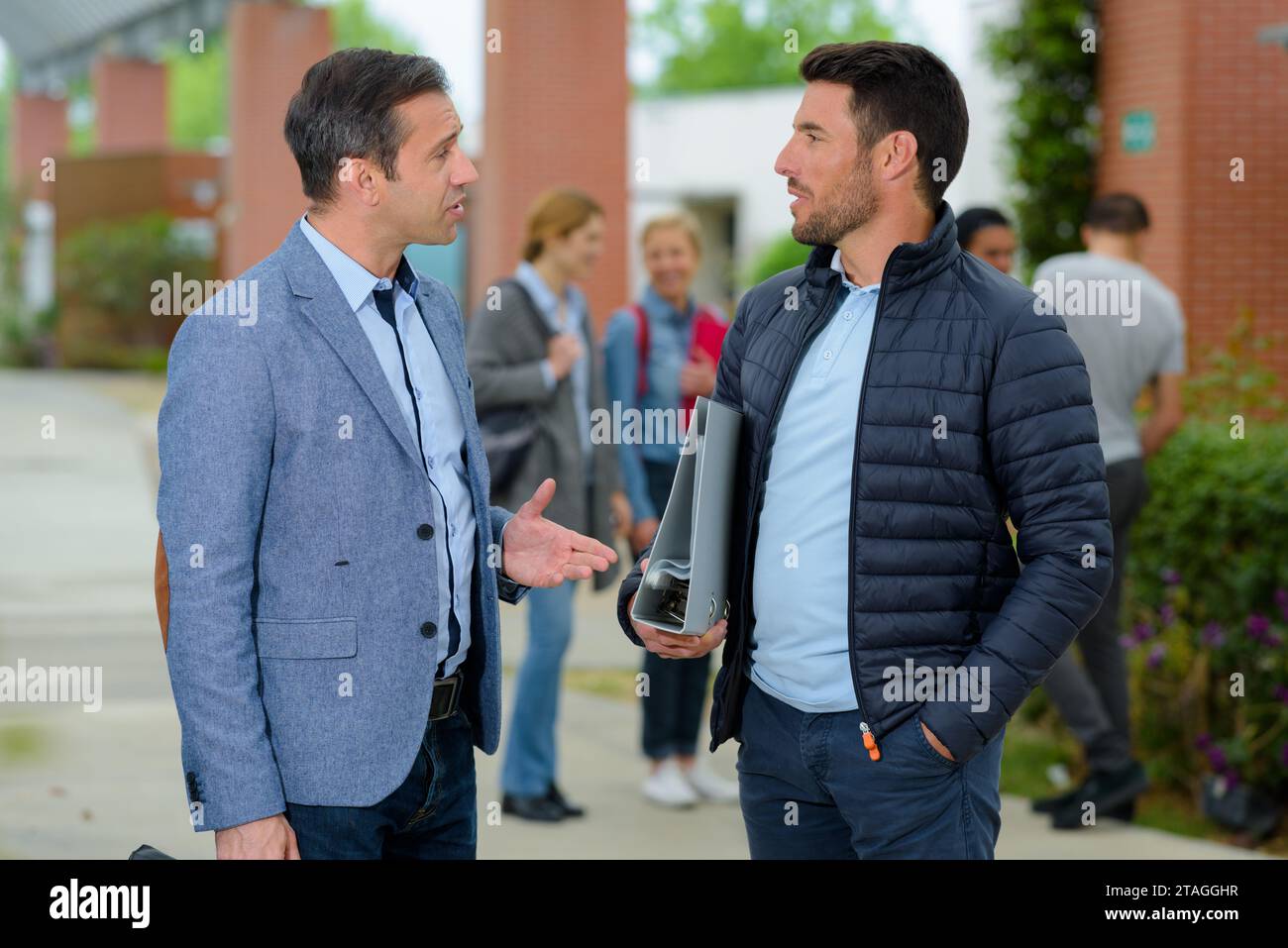 portrait of two men talking outdoors Stock Photo - Alamy