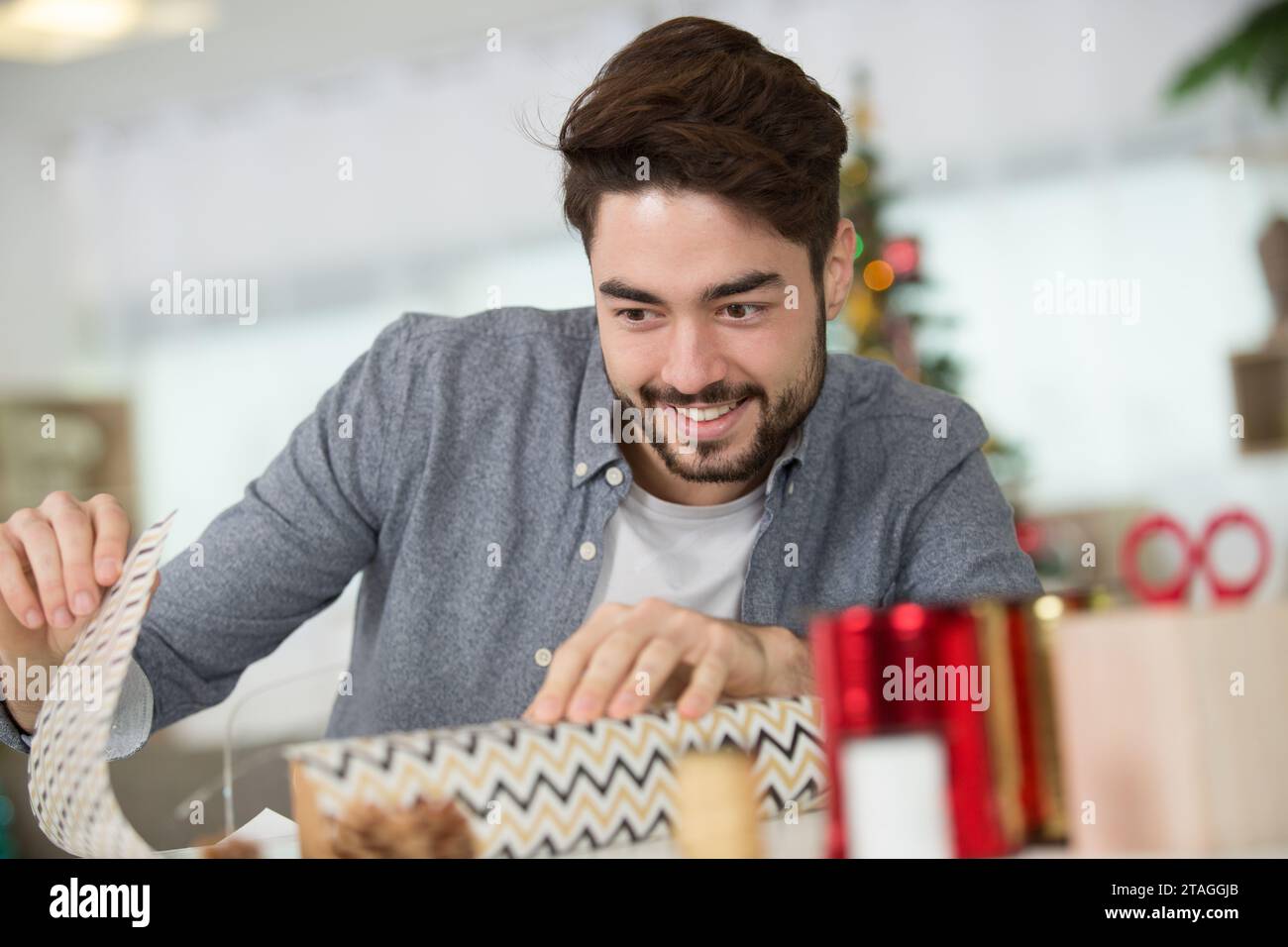 a man is wrapping boxes Stock Photo - Alamy