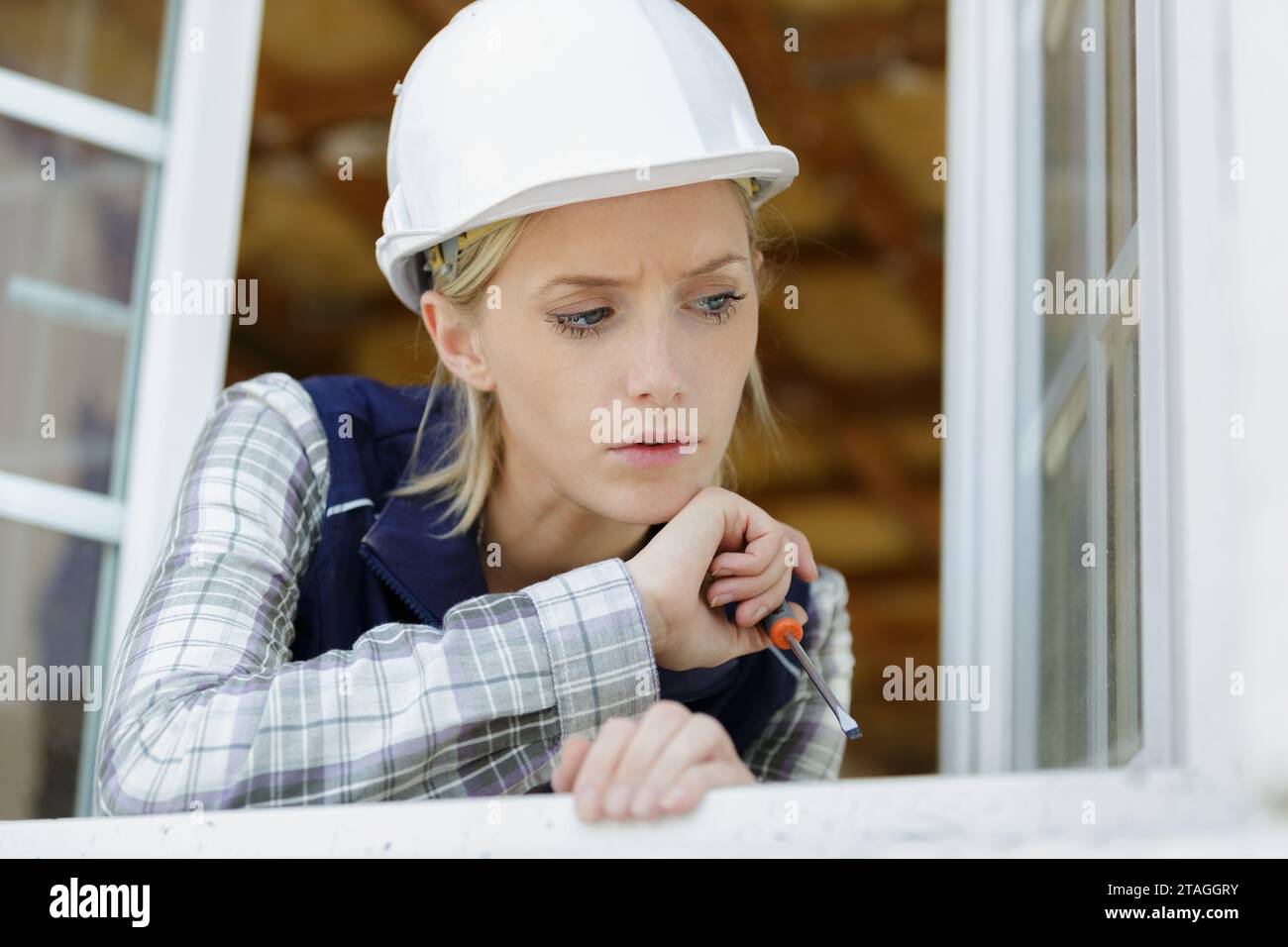 engineer builder woman in uniform looking out window Stock Photo - Alamy
