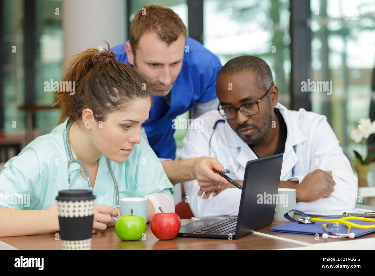 medical team chatting during break at the hospital Stock Photo - Alamy